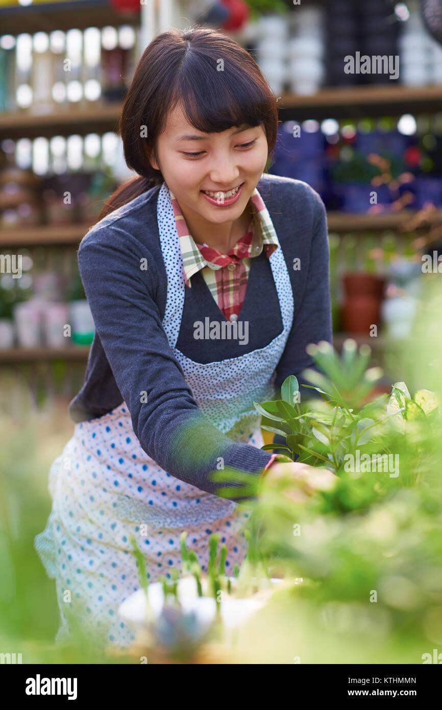 One Beautiful Chinese Woman Working in the Florist's Smile at Camera ...