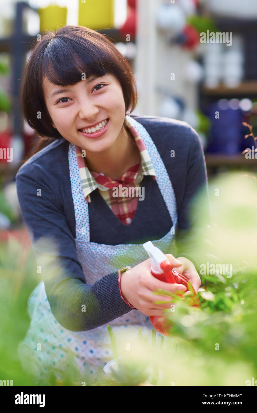 One Beautiful Chinese Woman Working in the Florist's Smile at Camera ...