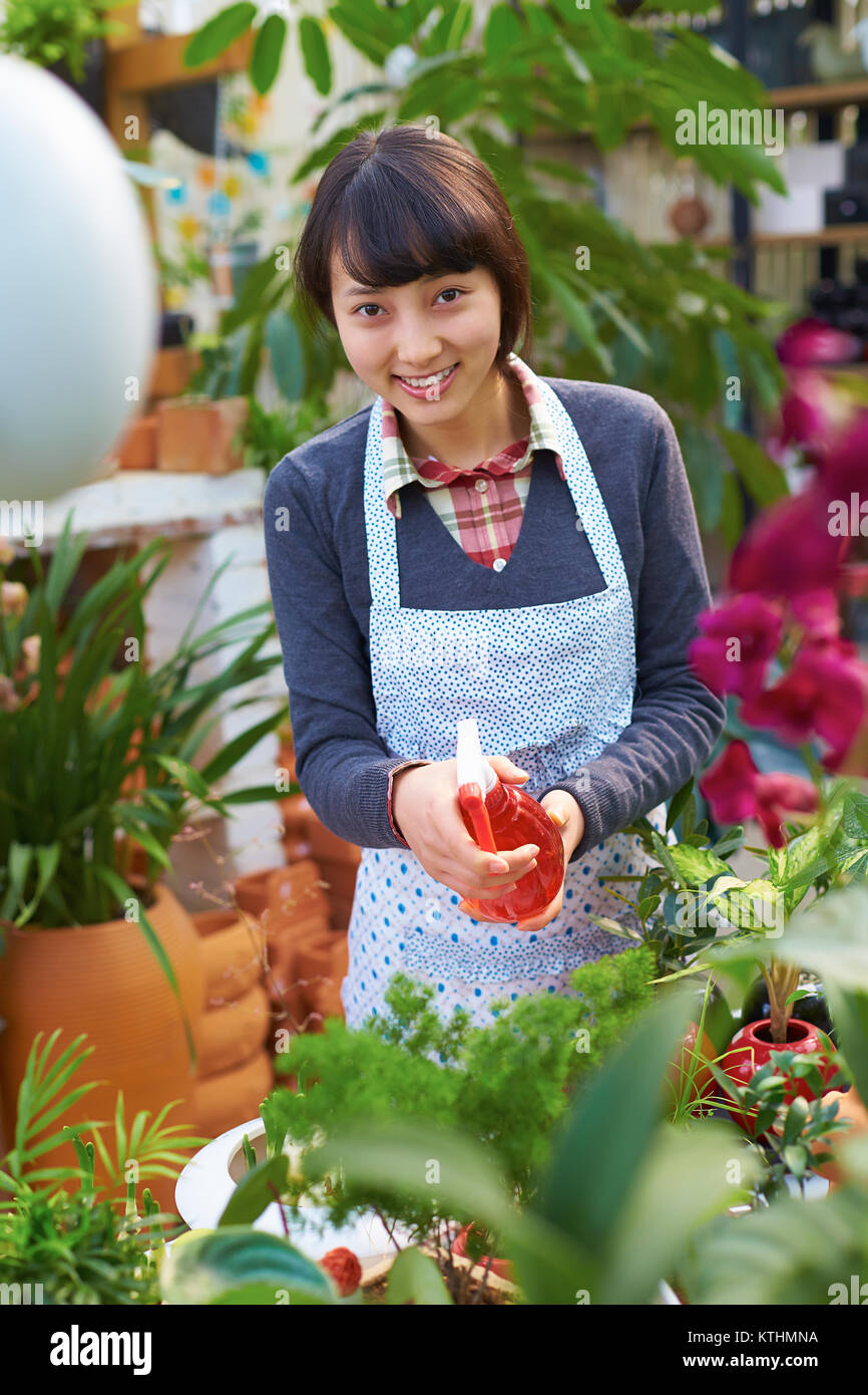 One Beautiful Chinese Woman Working in the Florist's Smile at Camera ...