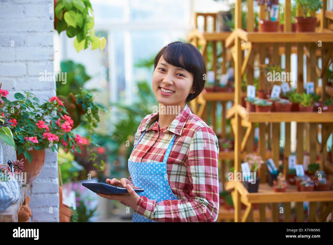 One Beautiful Chinese Woman Working in the Florist's Smile at Camera ...