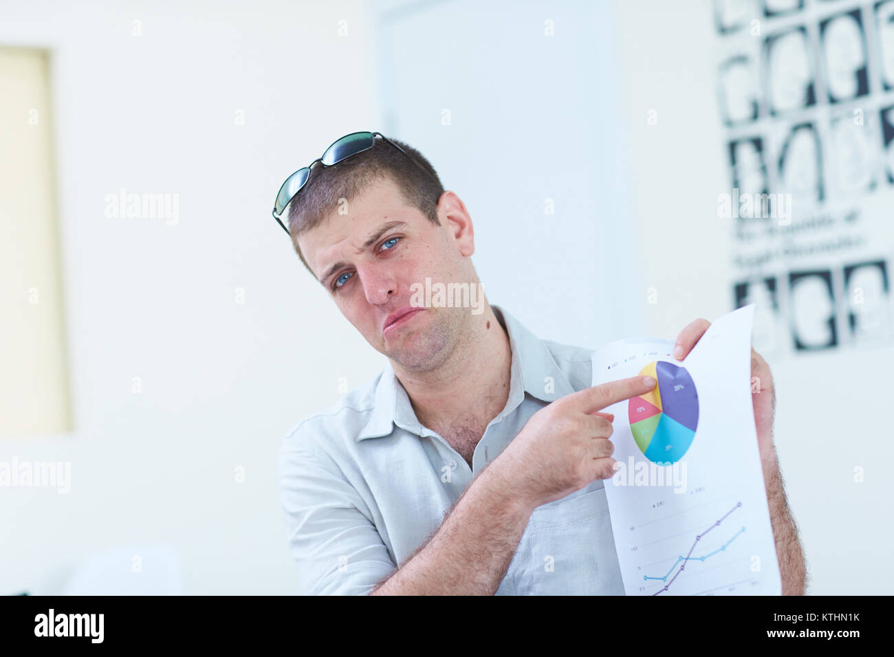 young businessman showing camera a bad performance chart Stock Photo ...