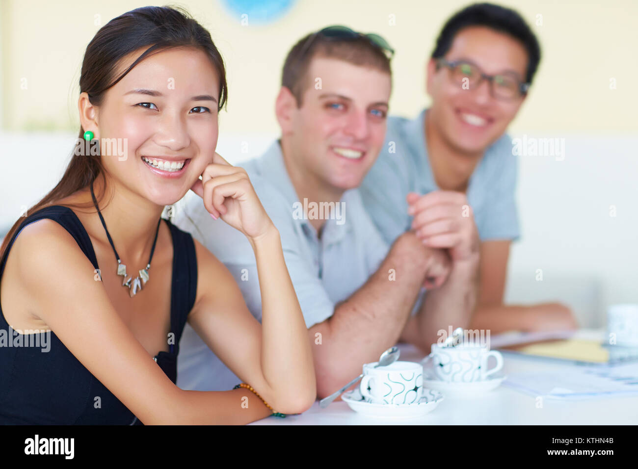 small business team of three looking at camera smile Stock Photo - Alamy