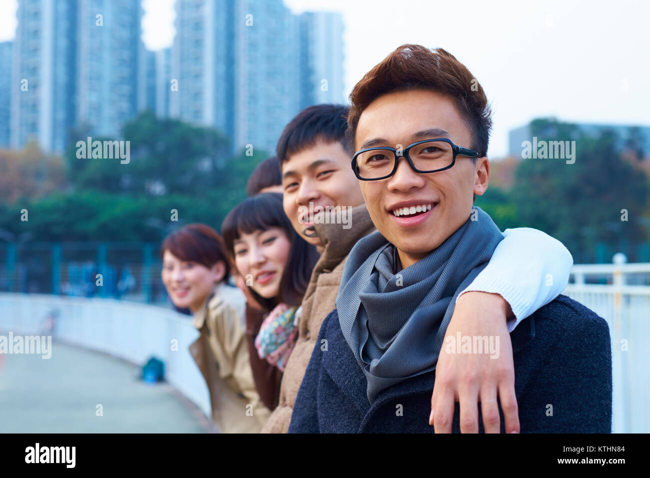 Chinese College Students sitting in line Looking at Camera smile Stock ...