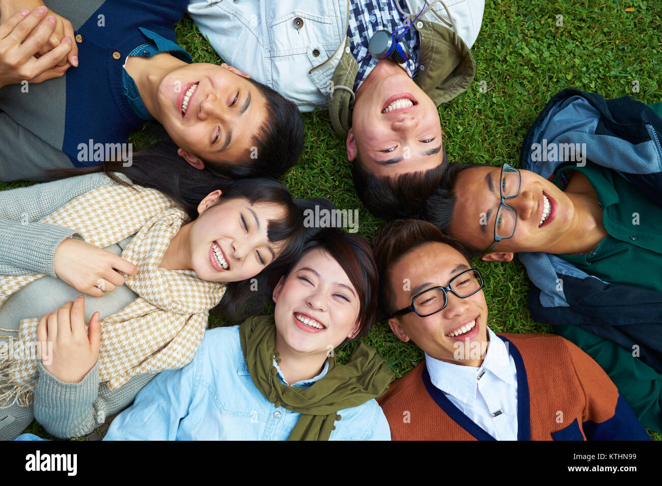 Group of Happy Chinese College Students Lying on Lawn Lokking up to the ...