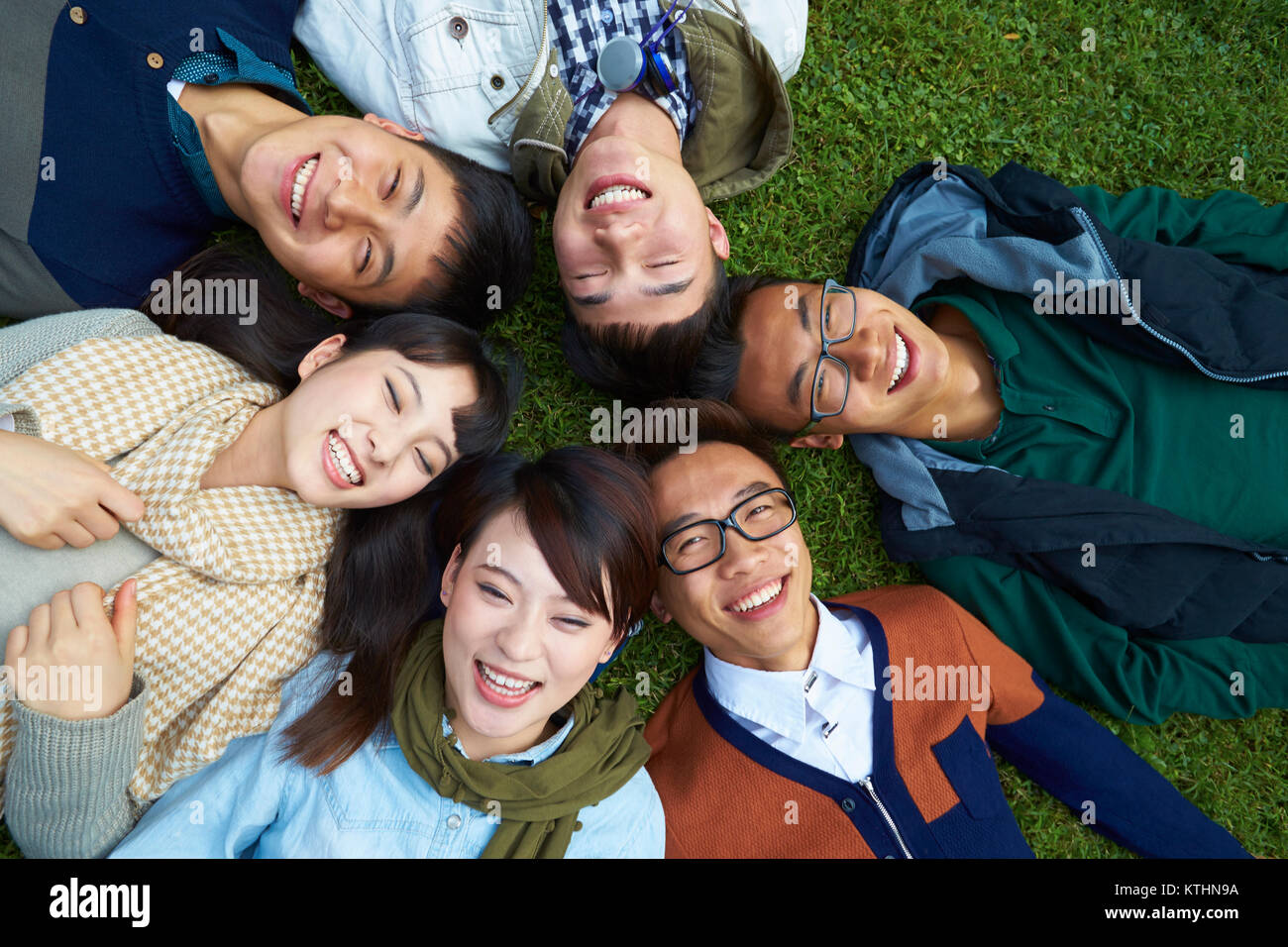 Group of Happy Chinese College Students Lying on Lawn Lokking up to the ...