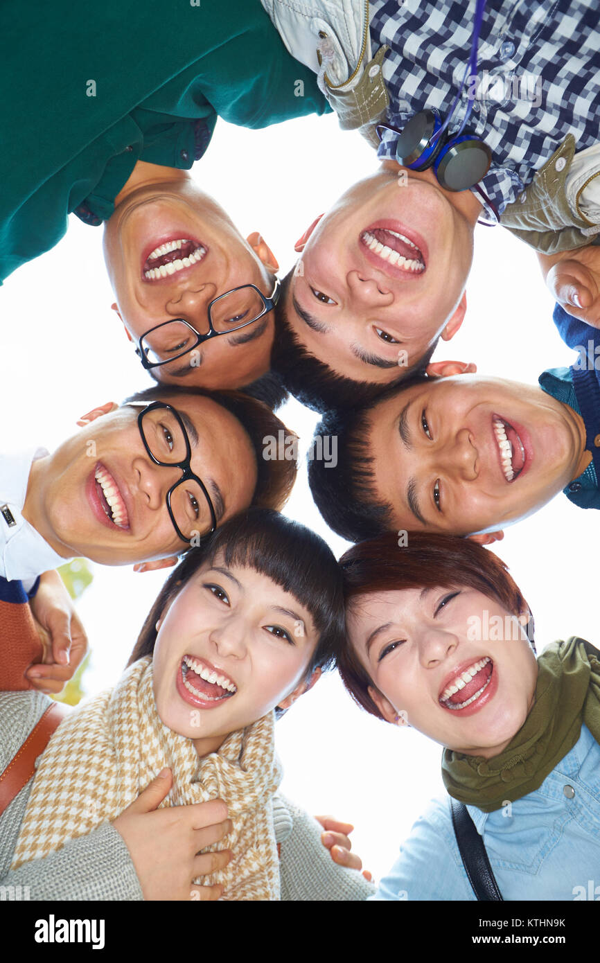 Group of Happy Chinese College Students Head to Head Looking Down to ...