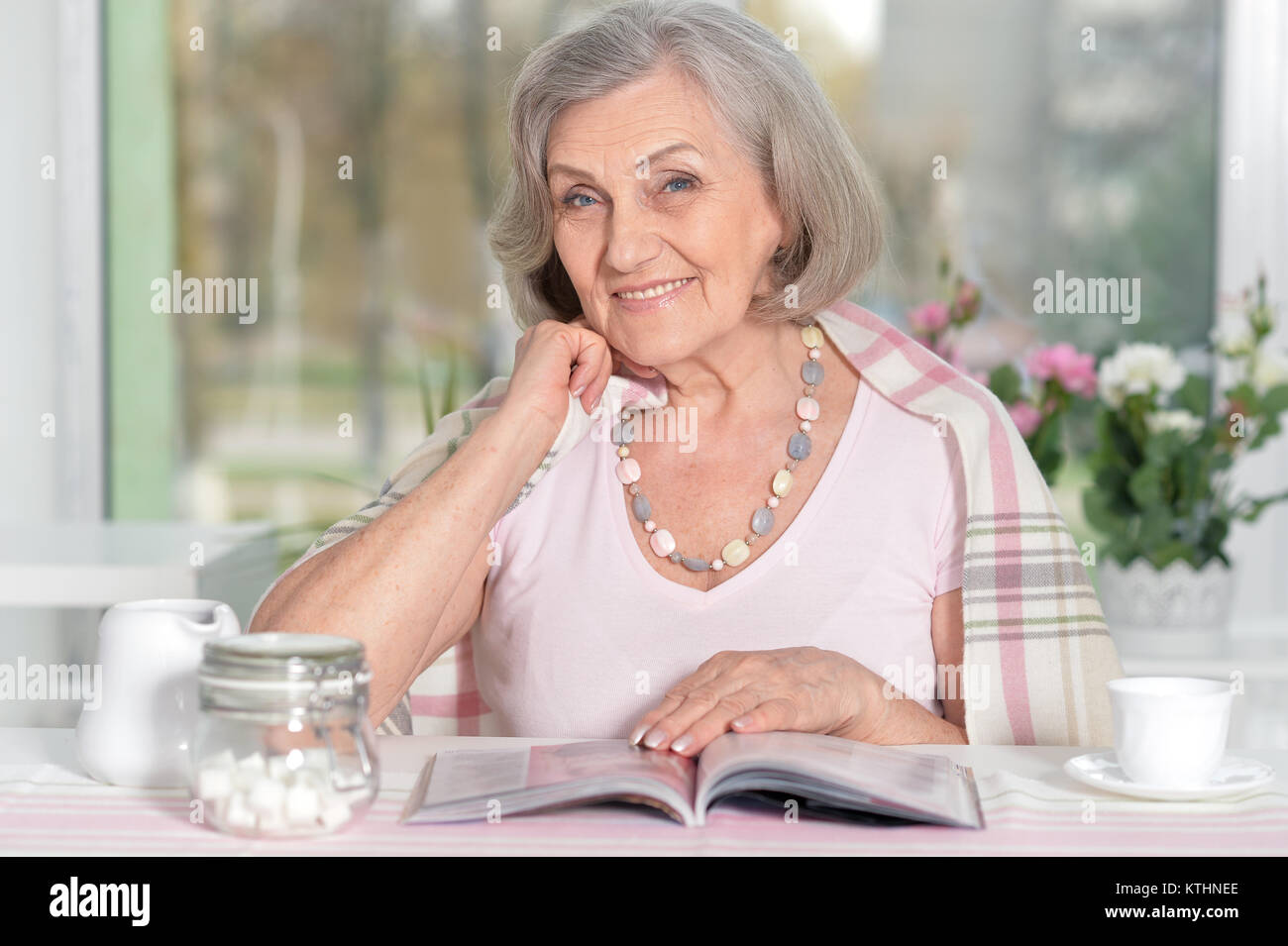 happy aged woman reading magazine Stock Photo - Alamy