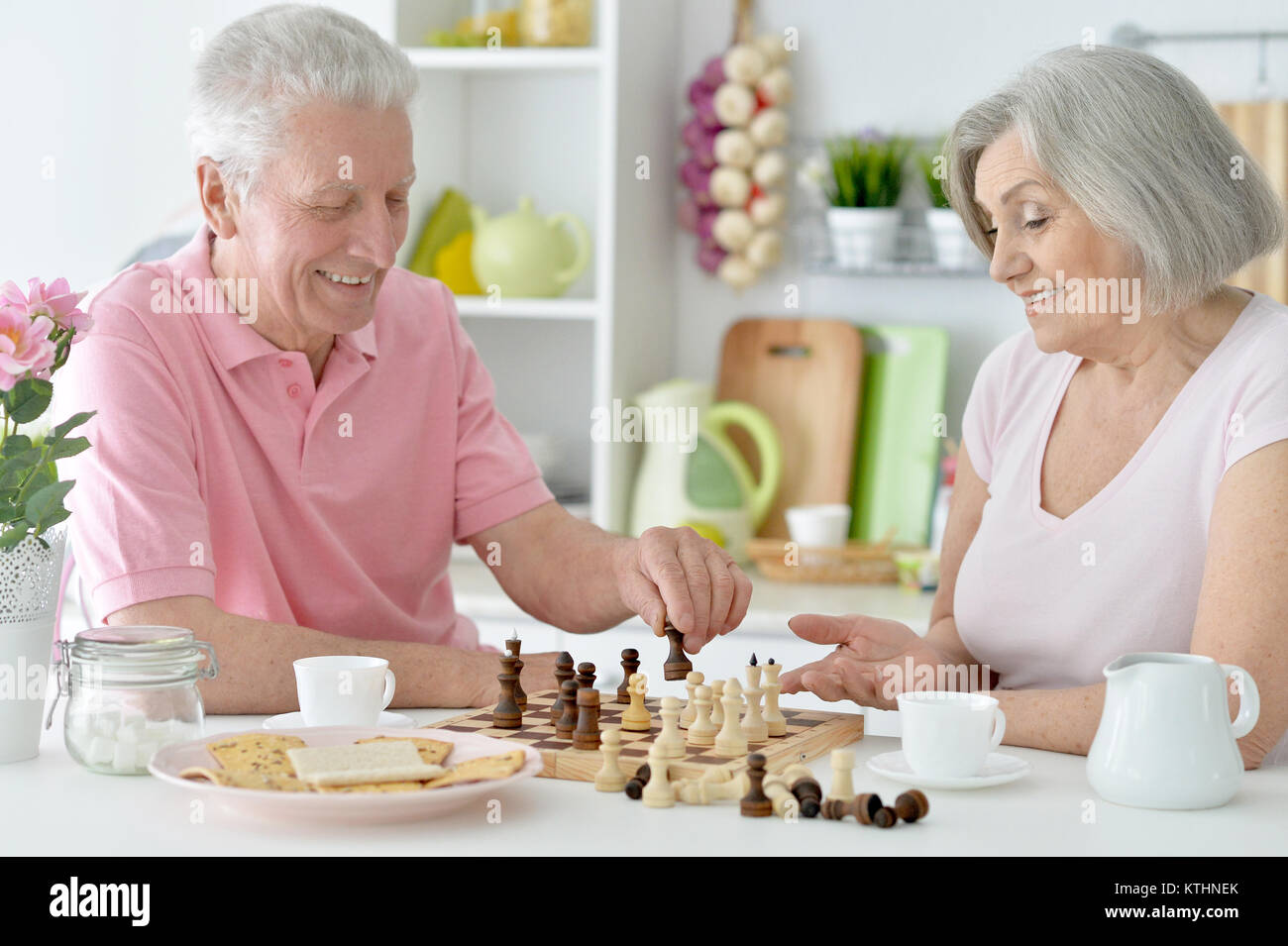 happy senior couple playing chess Stock Photo - Alamy