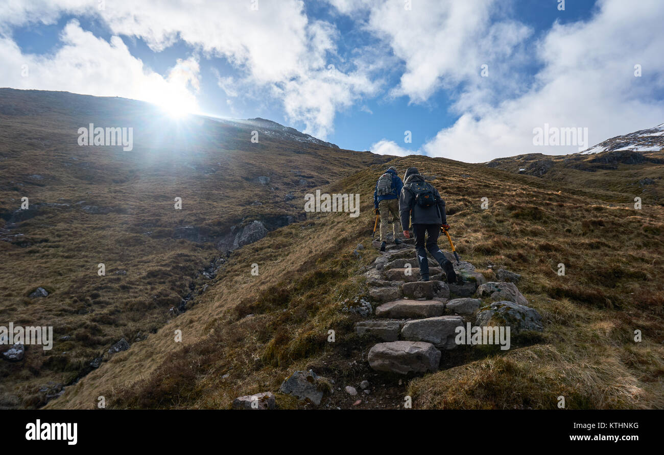 A couple walking up the mountain in Scottish highlands Stock Photo - Alamy