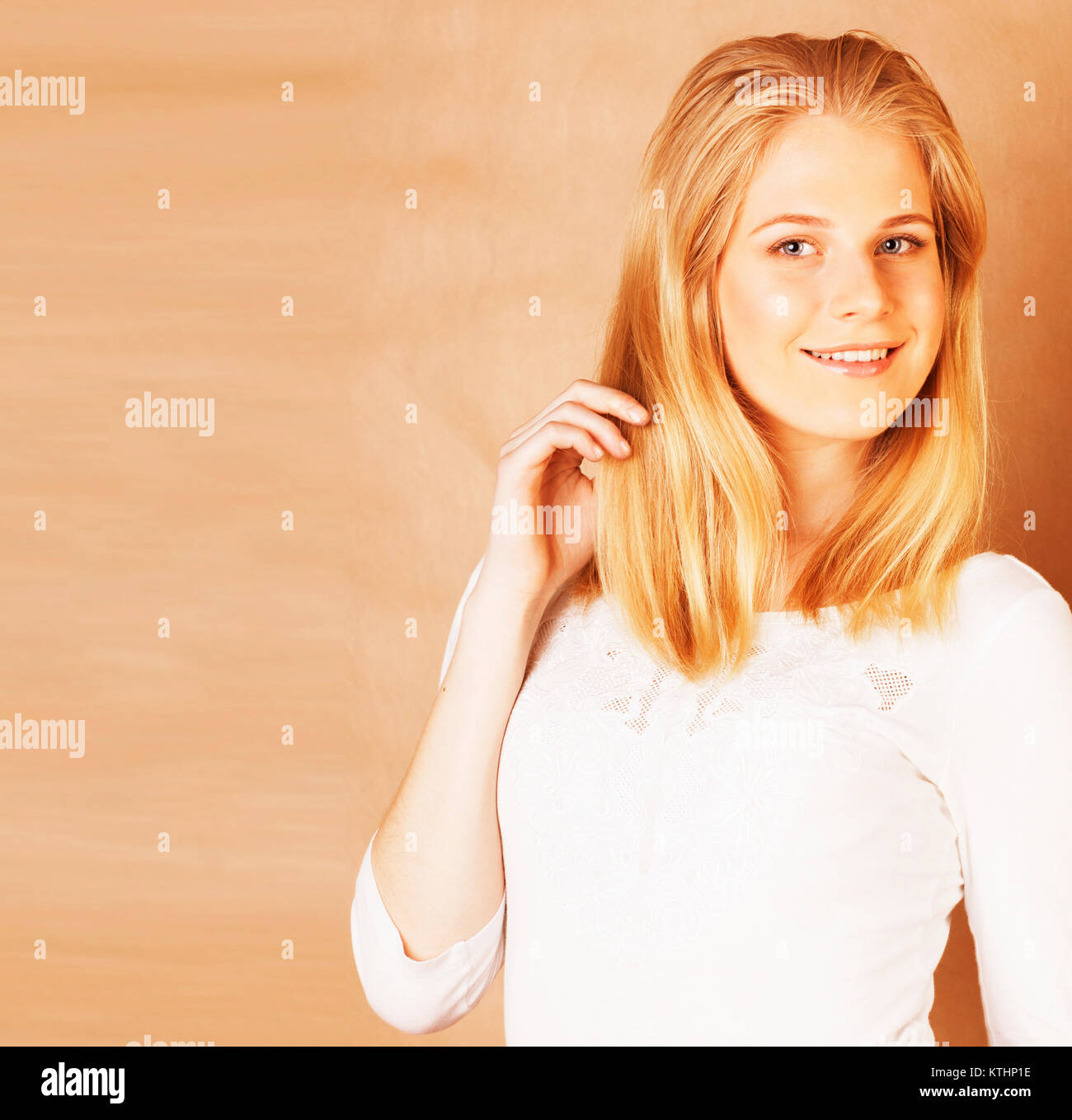 young cool blong teenage girl messed with her hair smiling close up on ...