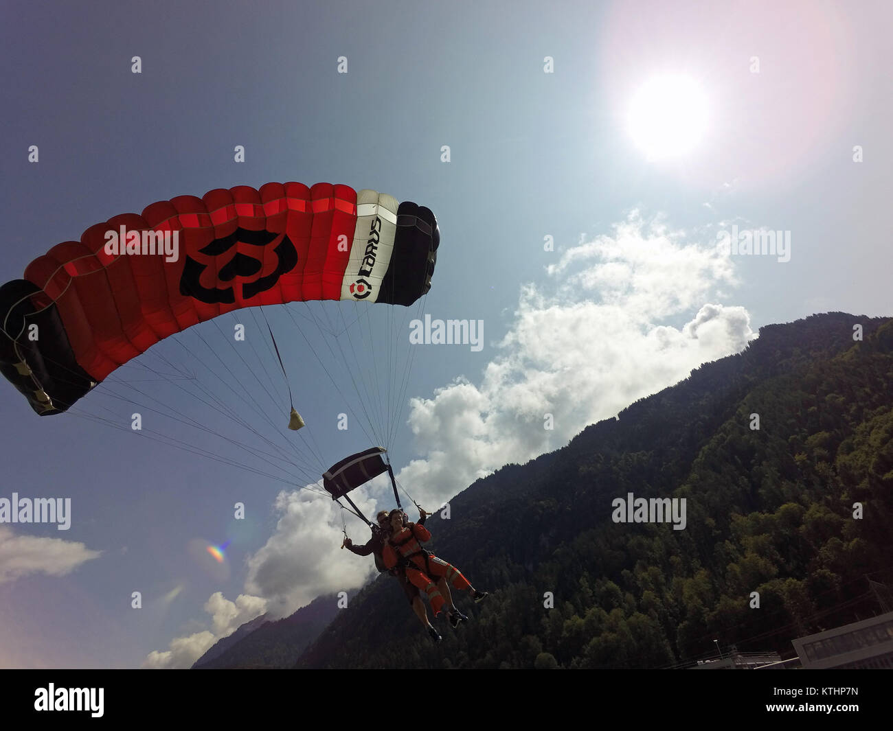 Tandem skydivers are flying under canopy and approaching the landing ...