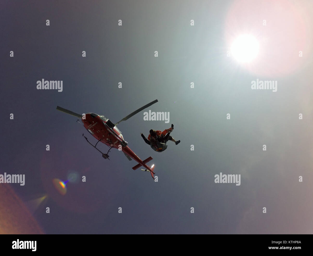 Wow, this tandem skydiving couple is jumping off a helicopter. The ...