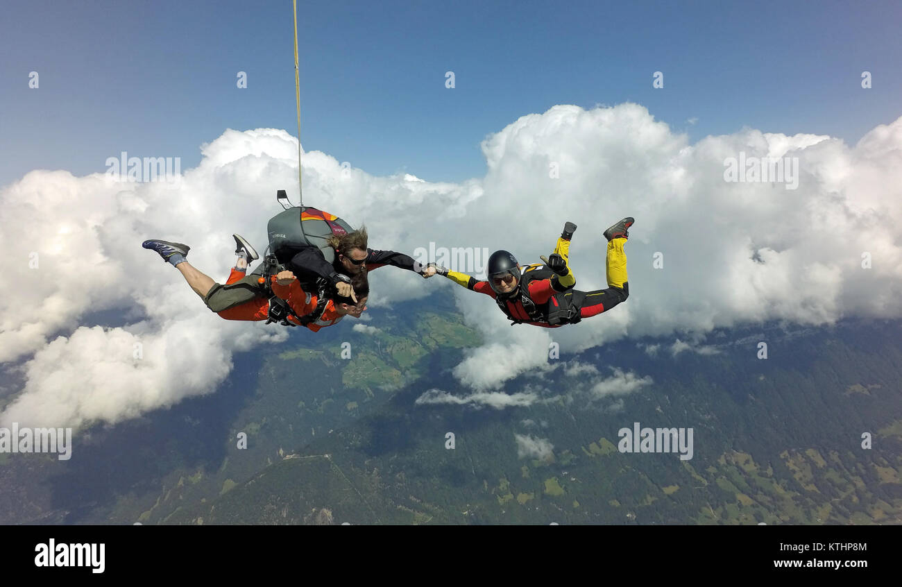 This tandem skydiving couple, plus the fun jumper are enjoying the ...