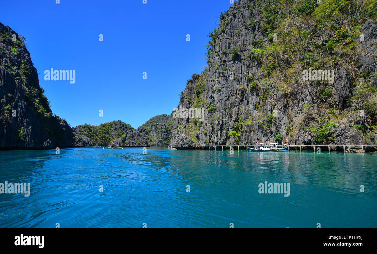 Clear turquoise sea or lagoon and speedboats in Coron Islands ...