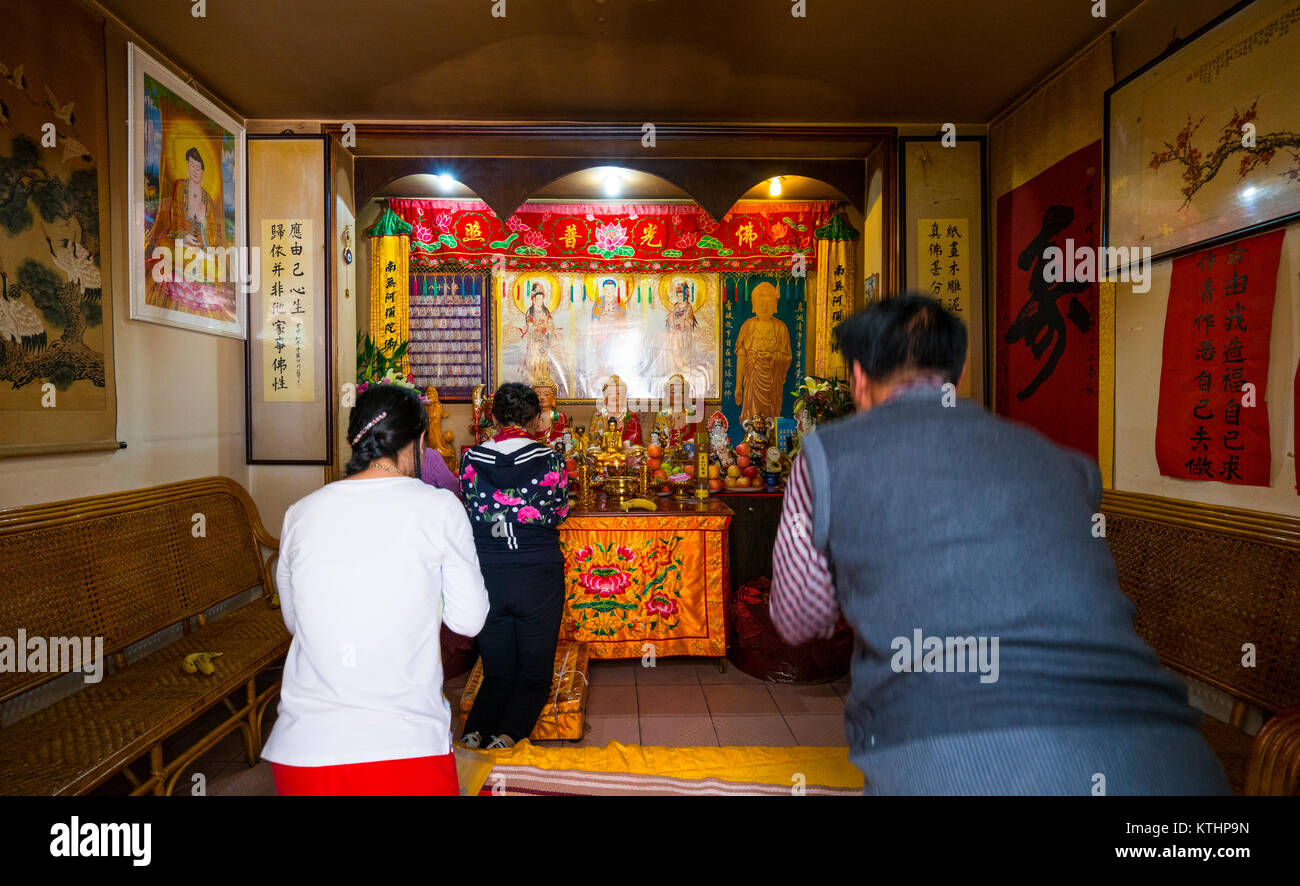 People doing a traditional praying before a Buddhist statue, Yuantong ...