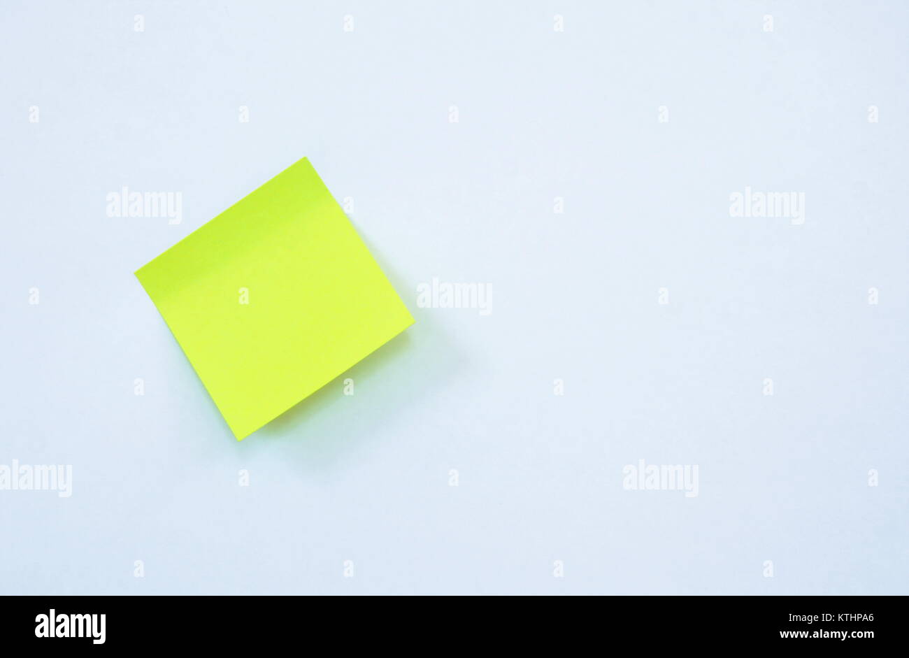 yellow paper note stick on white background Stock Photo - Alamy