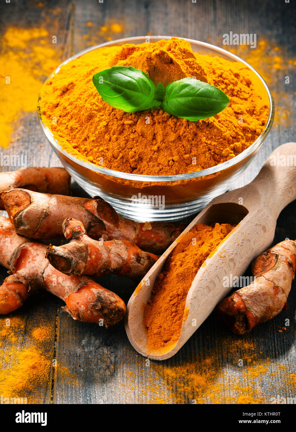 Composition with bowl of turmeric powder on wooden table Stock Photo ...