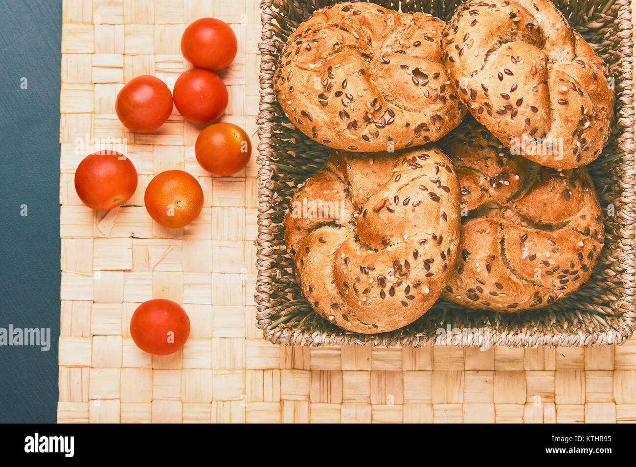 Breakfast server. Cooked buns on the table with cherry tomatoes Stock ...