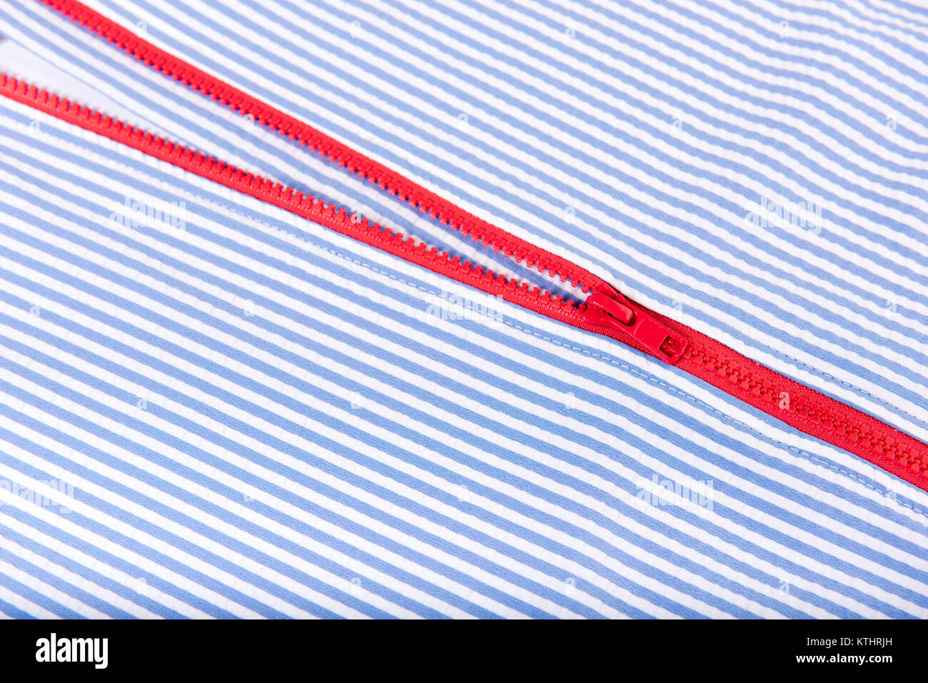 Red Zipper on White and Blue Striped Garment Stock Photo - Alamy