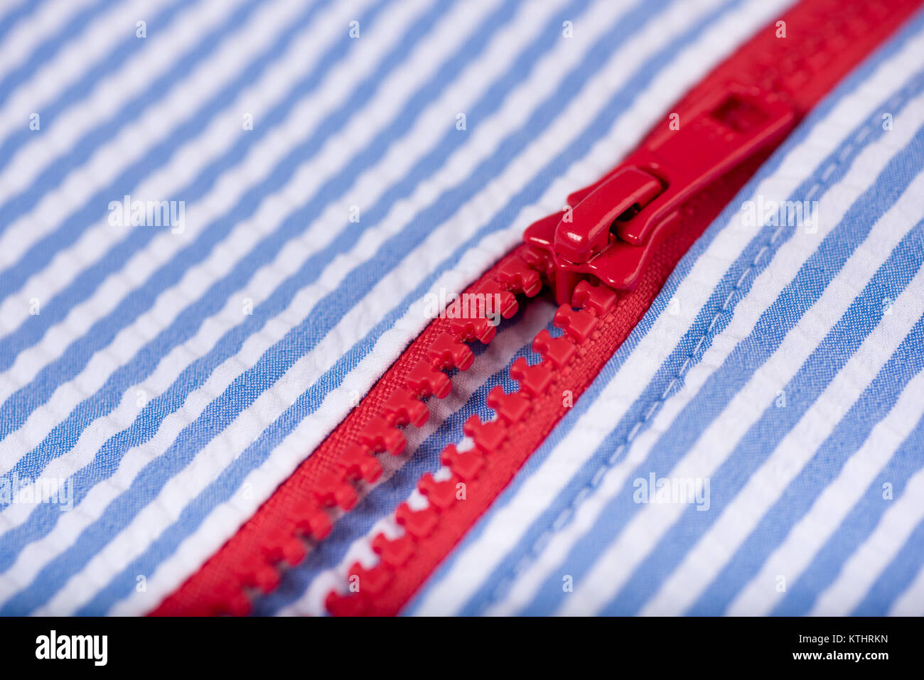 Red Zipper on White and Blue Striped Garment Stock Photo - Alamy