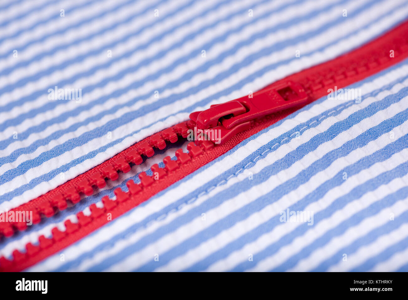 Red Zipper on White and Blue Striped Garment Stock Photo - Alamy