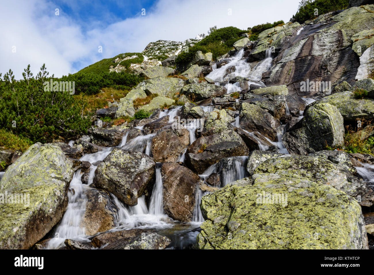 large Waterfall from ravine in autumn, long exposure, in mountain river ...