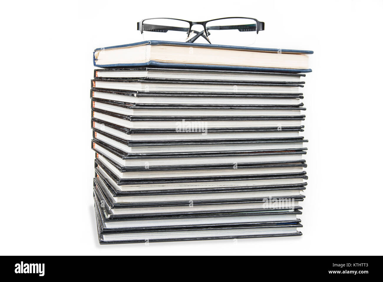 Stack of books with eyeglasses on the white background Stock Photo - Alamy