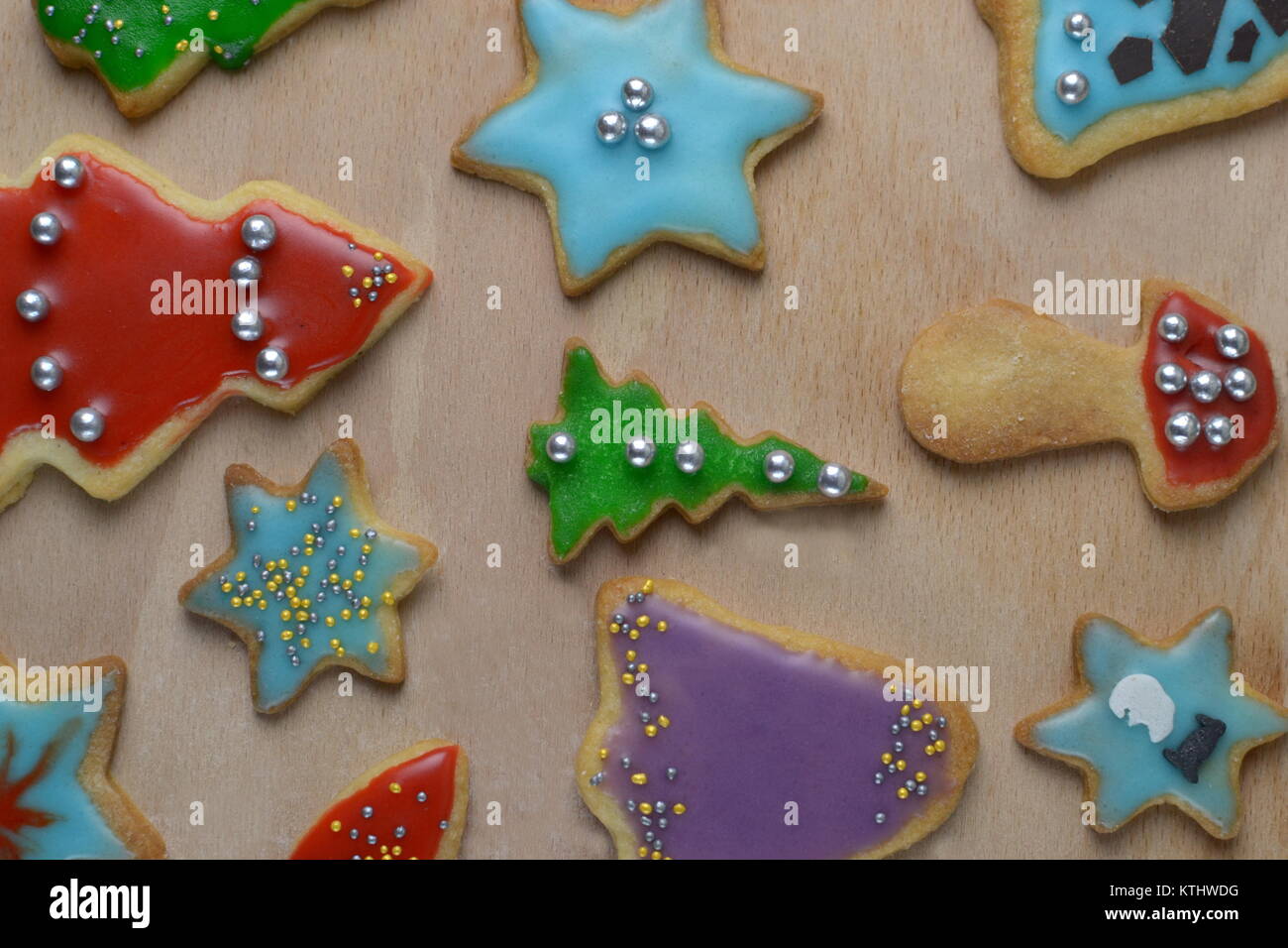 Pastel colored cookies with silver pearls on a bright wooden background ...