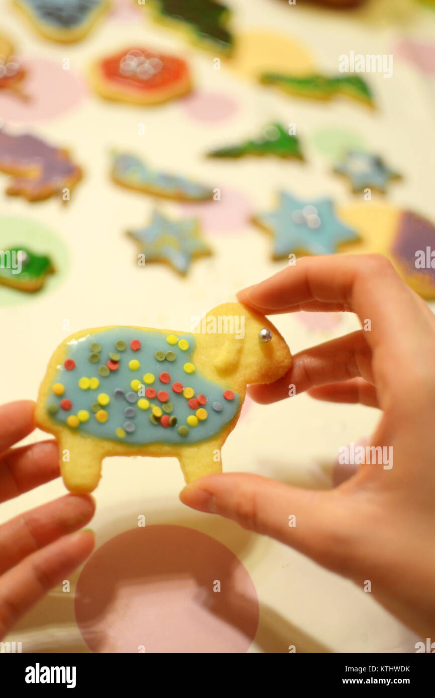 Pastel colored cookies with silver pearls on a bright wooden background ...