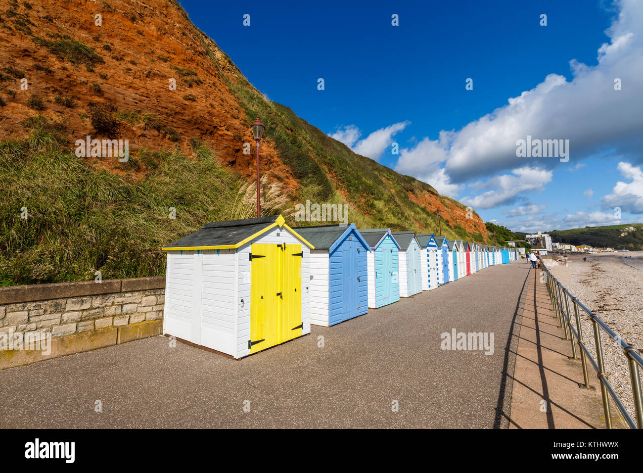 Colourful beach huts under the cliffs along the seafront promenade at ...