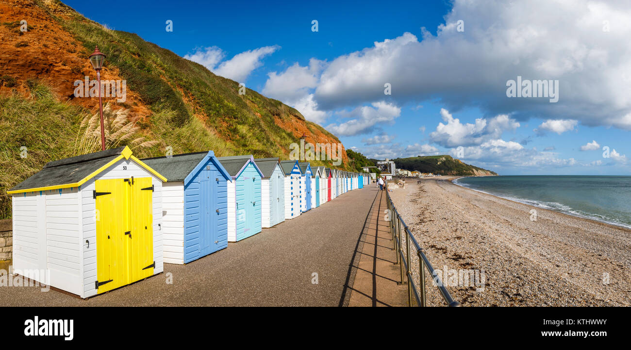 Colourful beach huts under the cliffs along the seafront promenade at ...