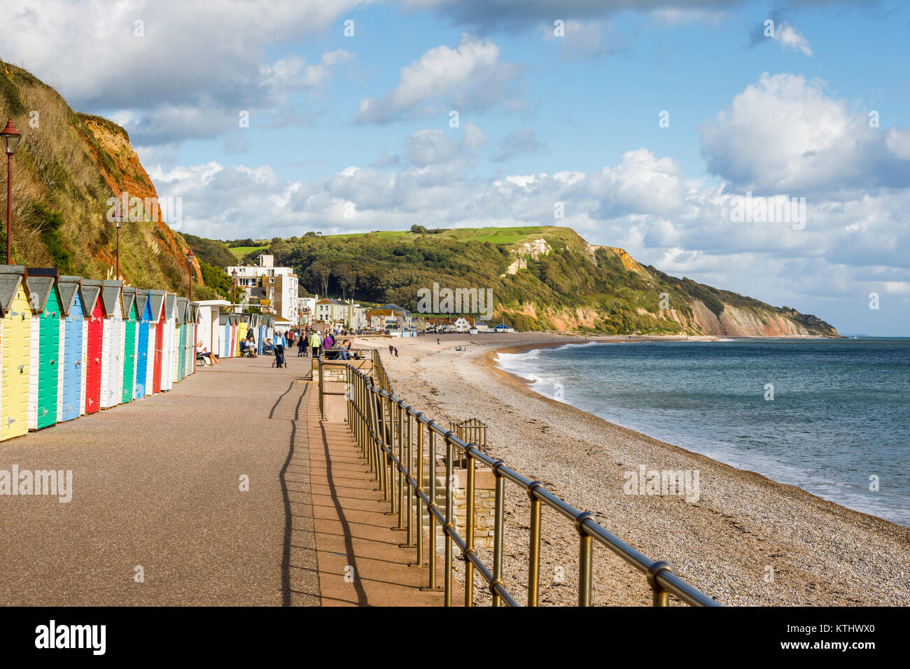 Colourful beach huts under the cliffs along the seafront promenade at ...