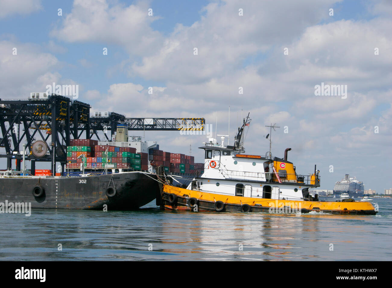 A large tugboat pushing a barge Stock Photo - Alamy