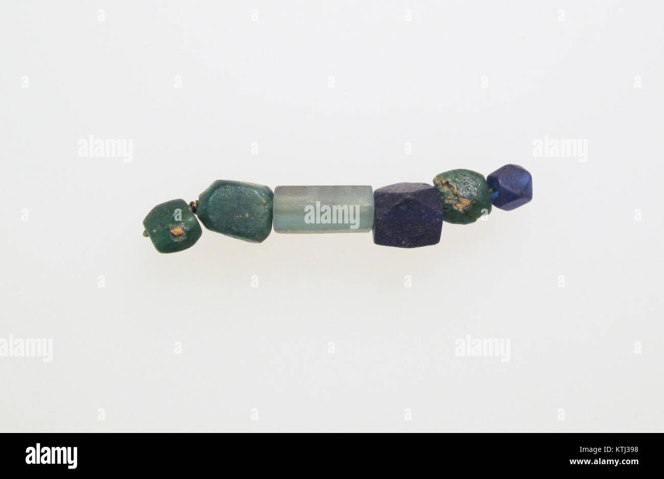 A collection of six beads, crafted in various materials, showcasing the ...
