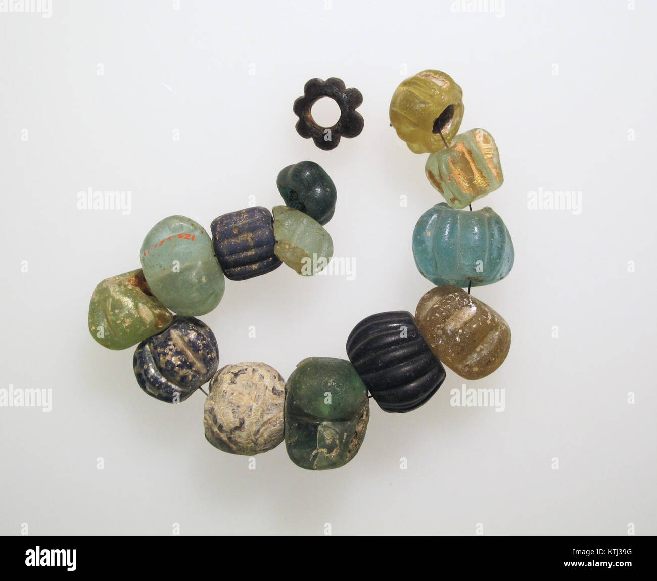 This collection of 14 beads, each varying in color and shape, is an ...