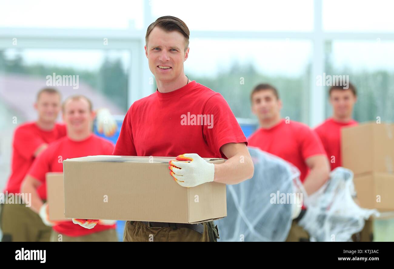 foreman and workers with boxes of building materials Stock Photo - Alamy