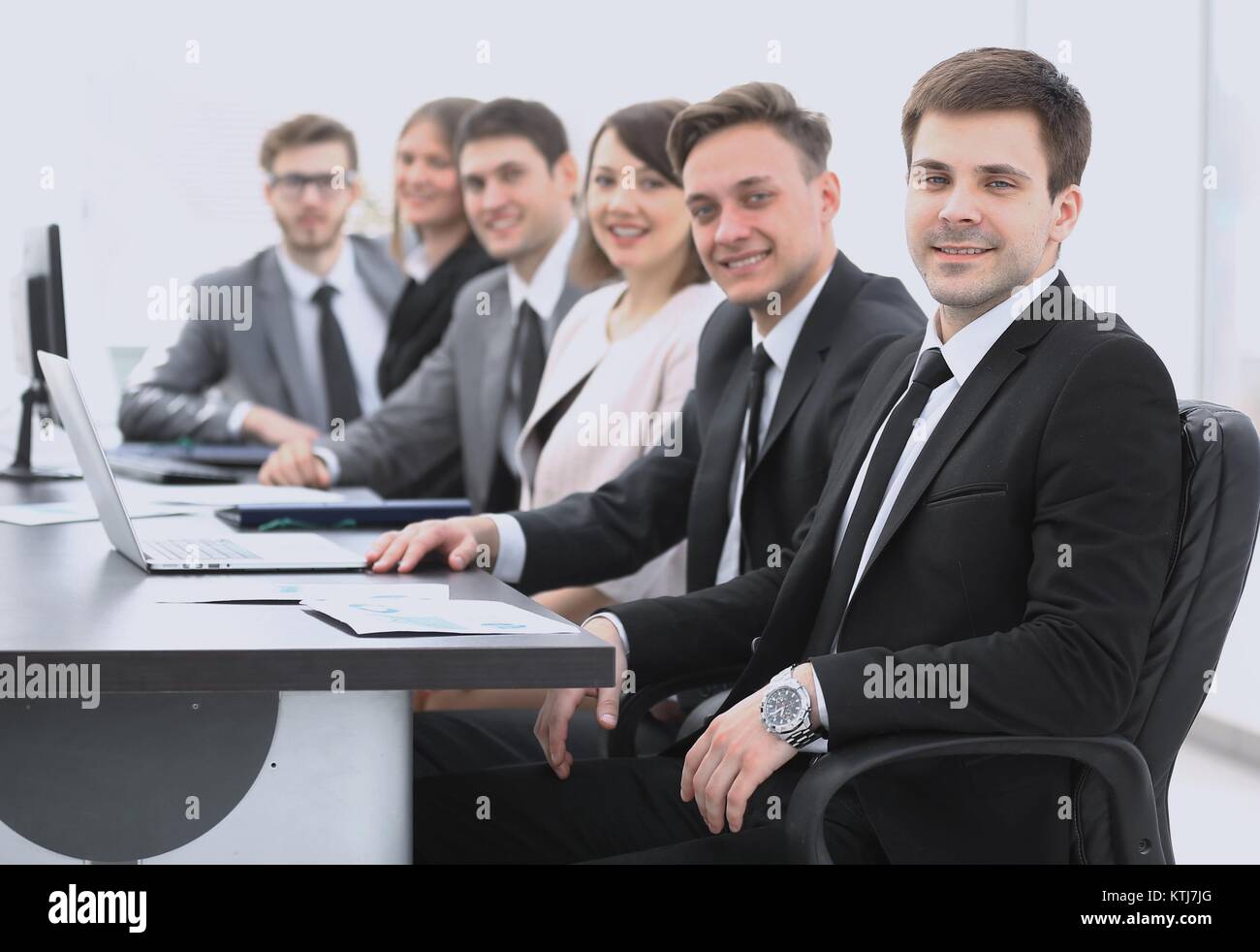 project Manager and professional business team sitting at Desk Stock ...
