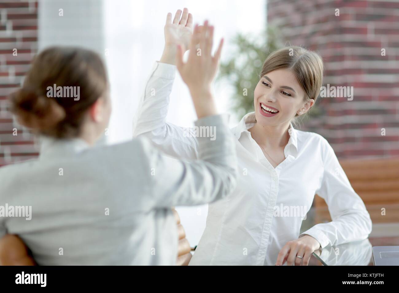 members of the business team giving each other a high five Stock Photo ...