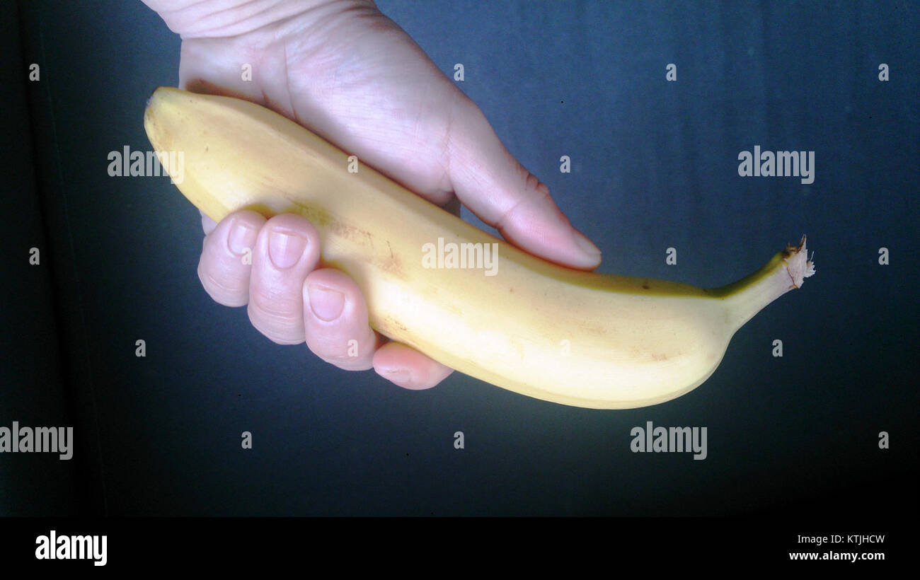 Banana in hand Stock Photo - Alamy