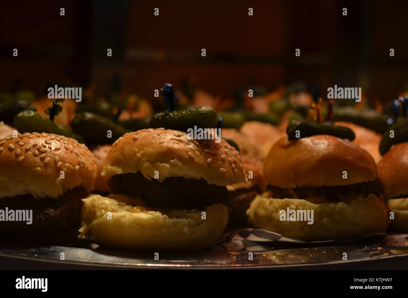 Mini beef burgers are small-sized sandwiches made with seasoned beef ...