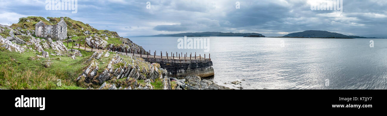 The rotten pier at Craignish point with the Sound of Jura and the ...