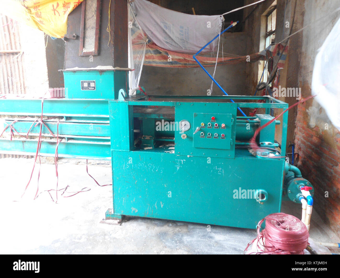 A bagasse baling machine in Hainan, used for compressing sugarcane ...