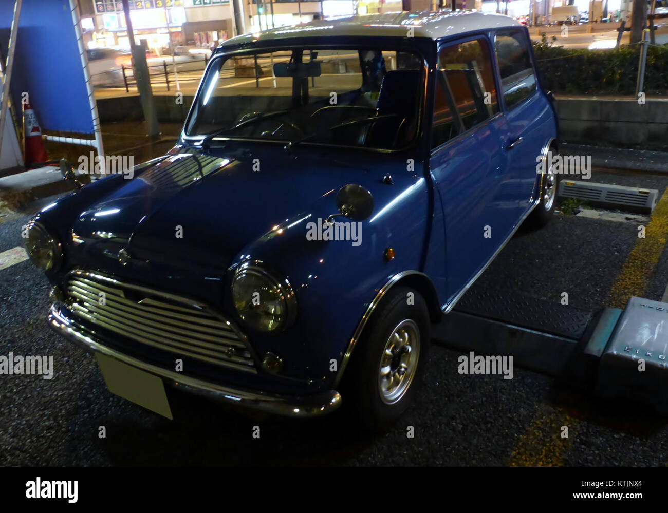 This image shows an Austin Mini Cooper (ADO50S) parked at night ...