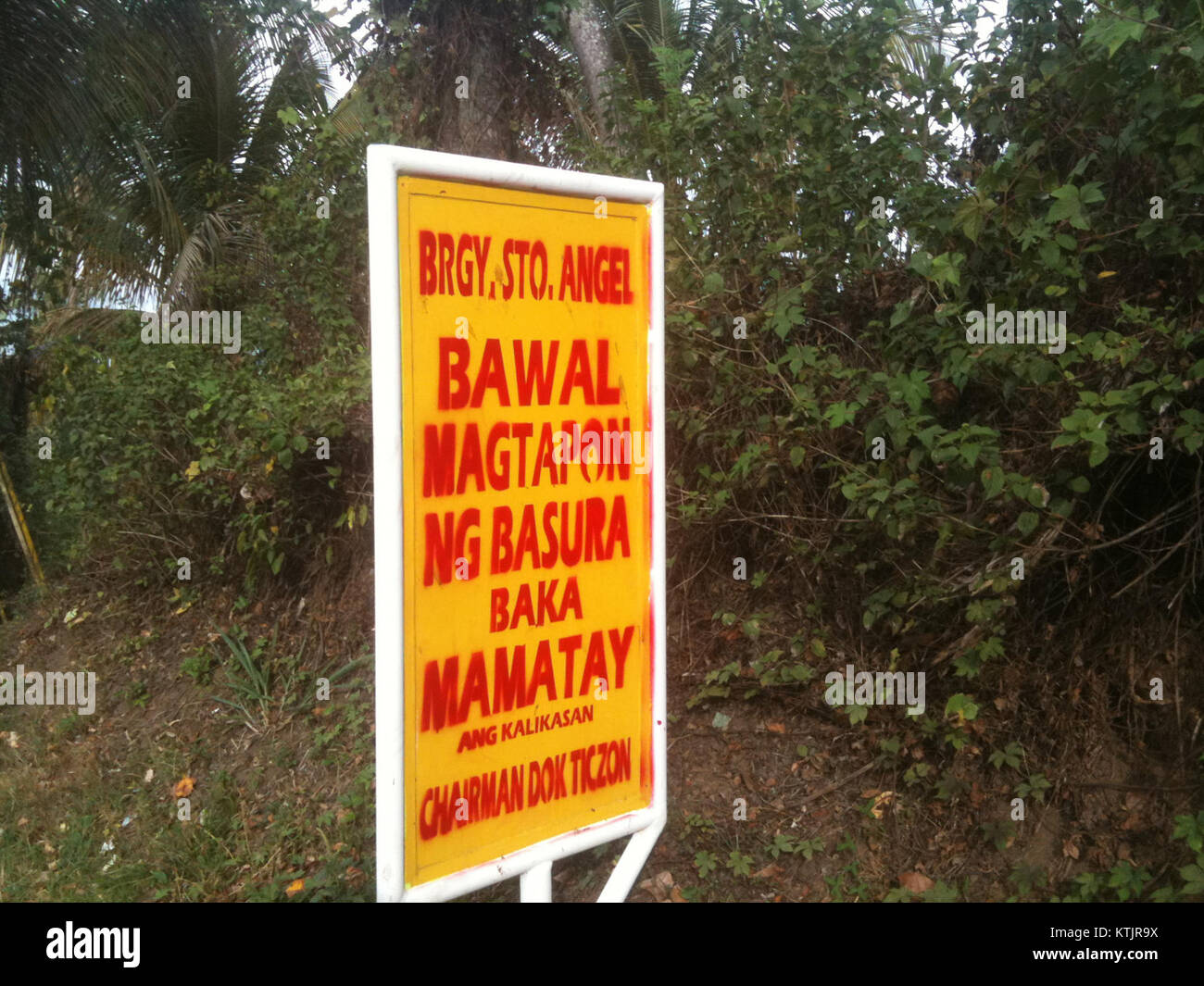 This image shows a 'No Dumping' sign posted in Brgy. Santo Angel, a ...
