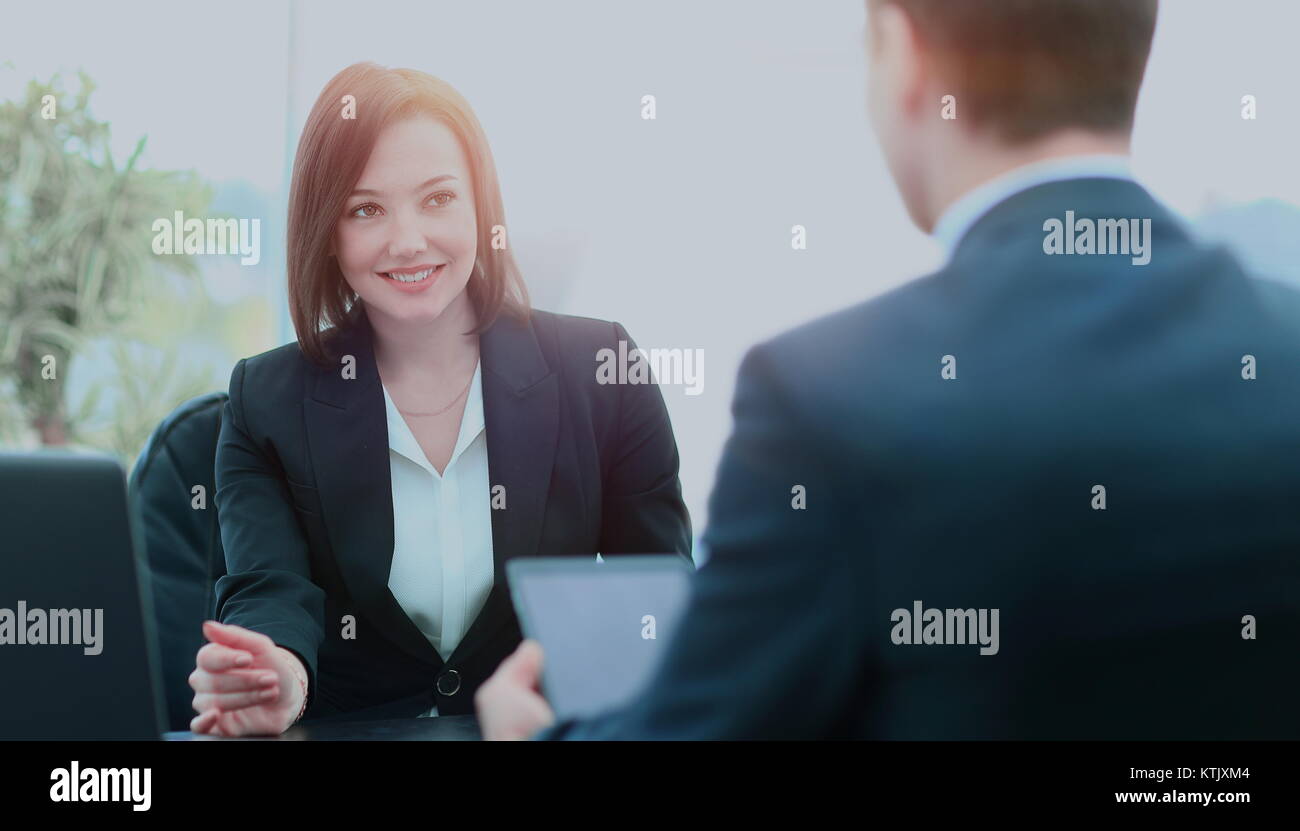 Beautiful young businesswoman conducting a job interview seated at her ...