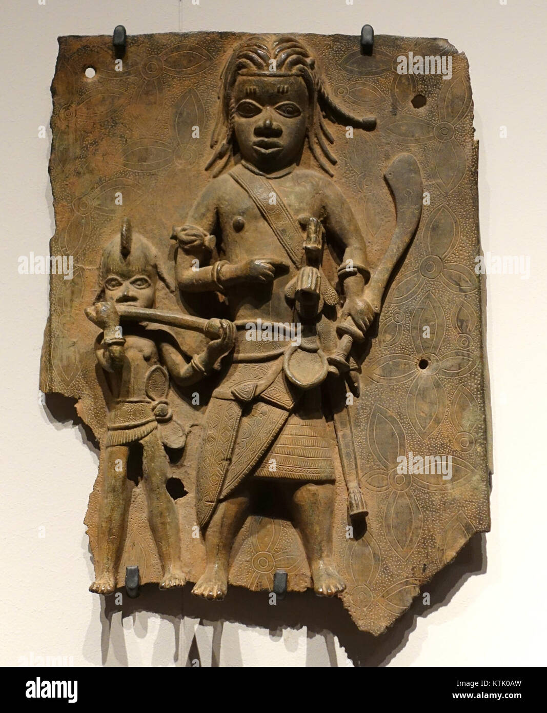 This Benin plaque, displayed in the Ethnological Museum of Berlin, is ...
