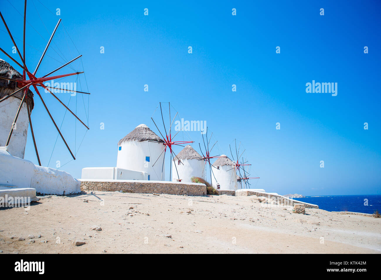 Famous view of traditional greek windmills on Mykonos island at sunrise ...