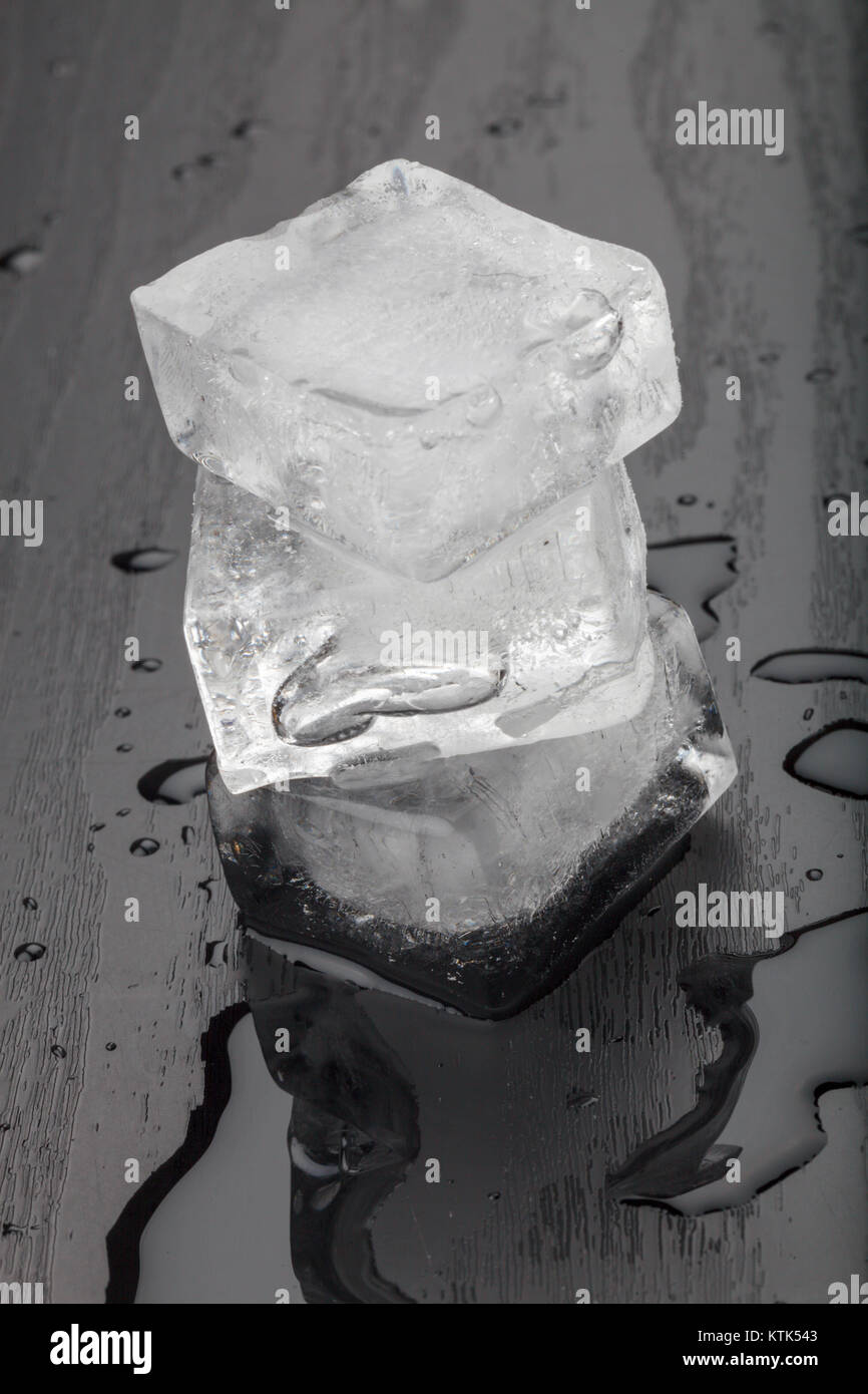 ice cubes on black table background Stock Photo - Alamy