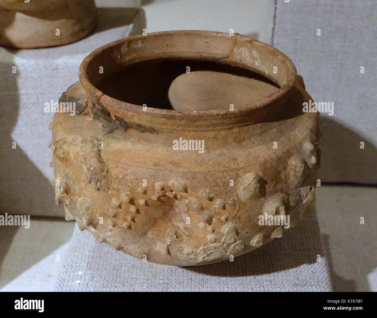 This Roman barbotine pot, dating from the 1st to 4th century AD, is ...