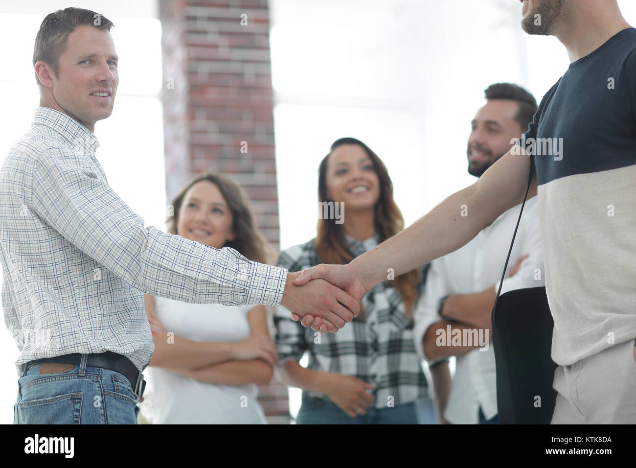 handshake business partners in the creative office Stock Photo - Alamy
